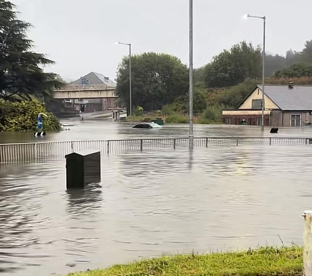 Cwmbwrla Roundabout closed after cars submerged in flood water ...